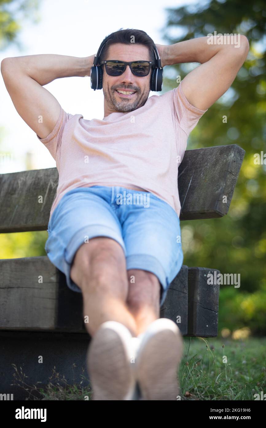 man relaxing on bench during week-endc Stock Photo - Alamy