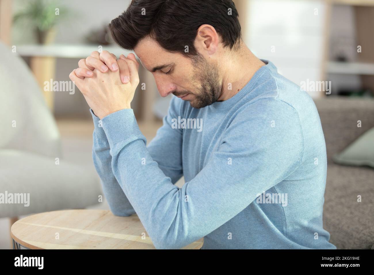 worried man praying at home Stock Photo - Alamy