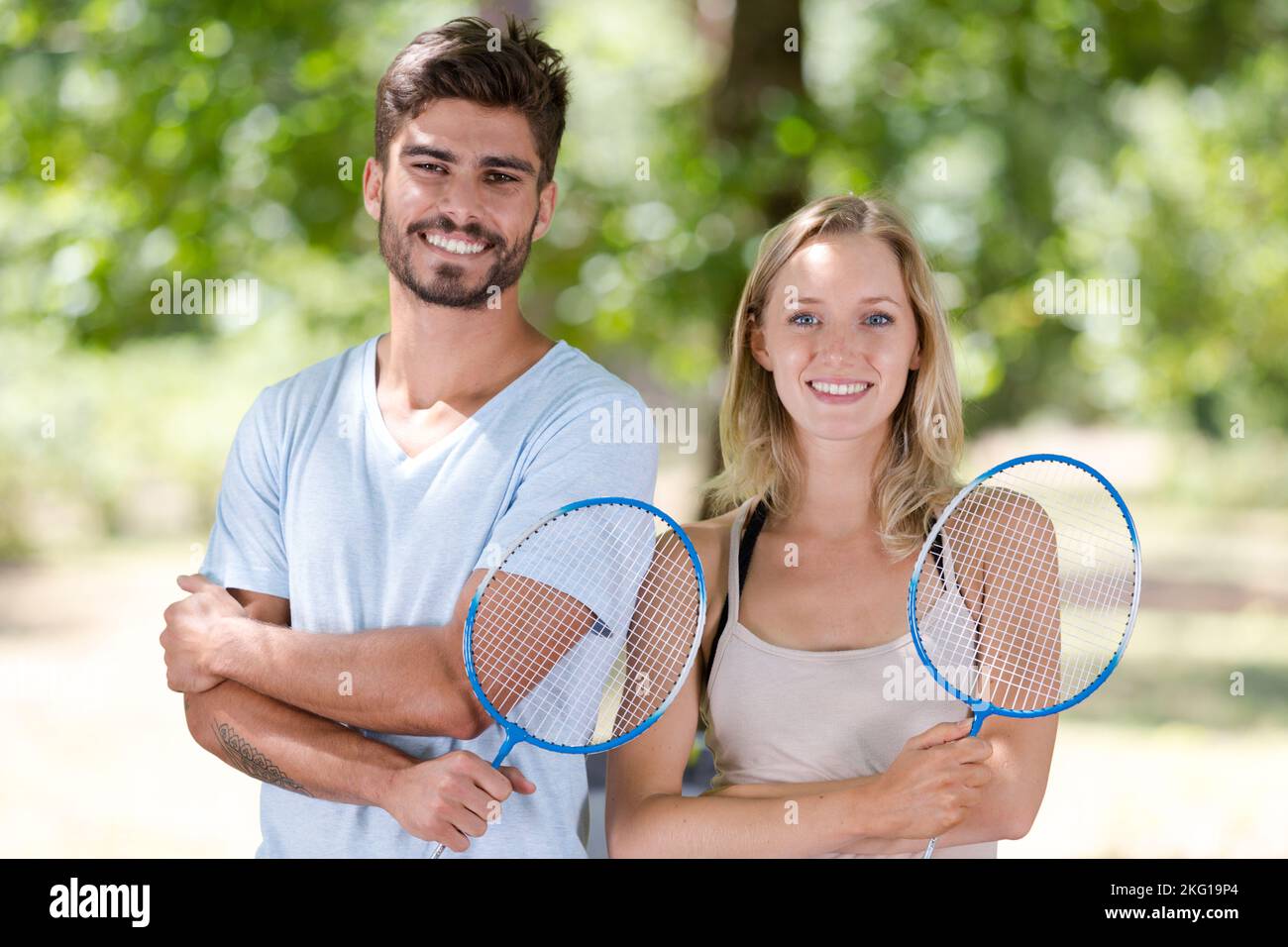Happy people playing badminton together hi-res stock photography and ...