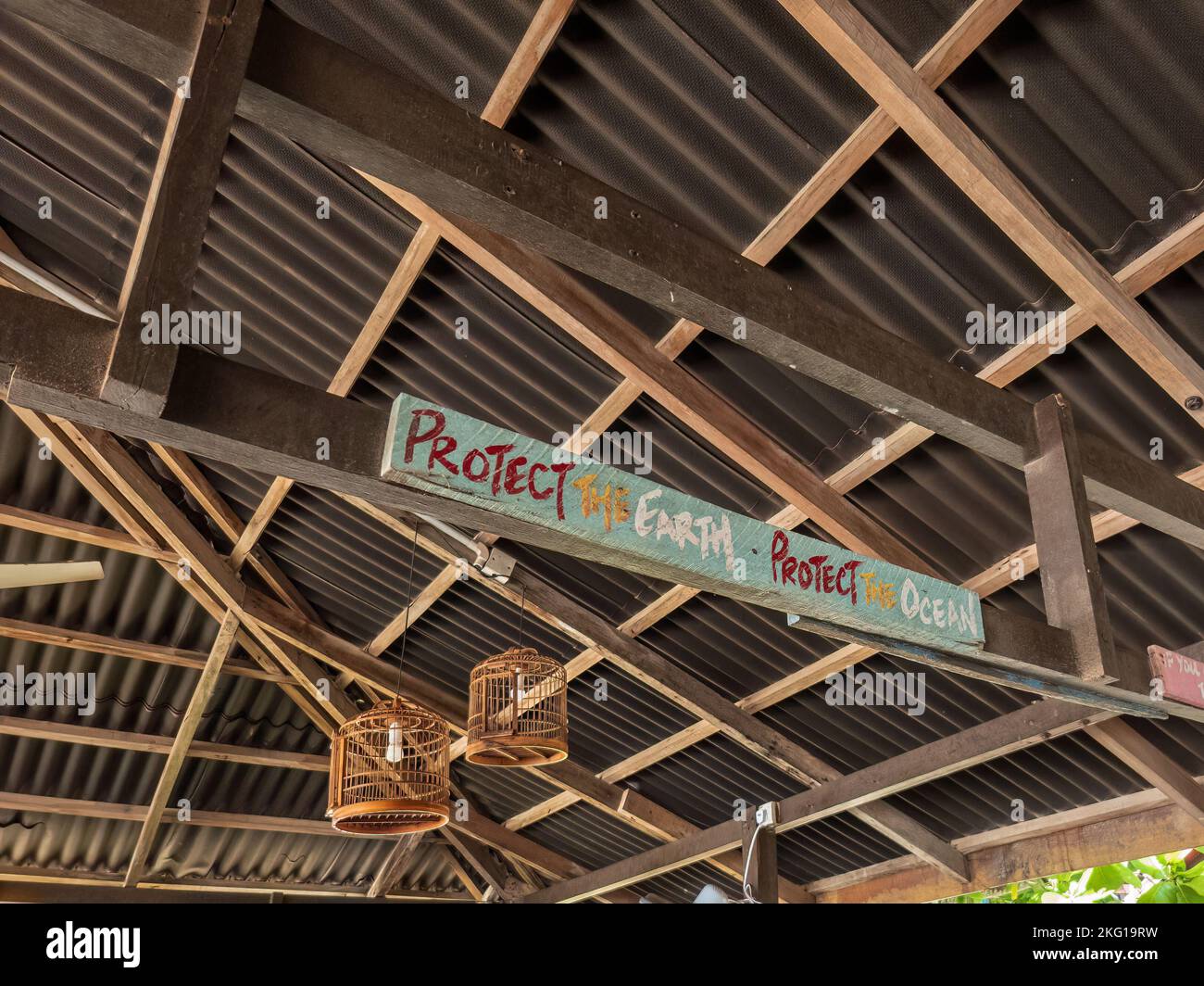 Protect the earth, protect the ocean wording on the wooden sign near ...