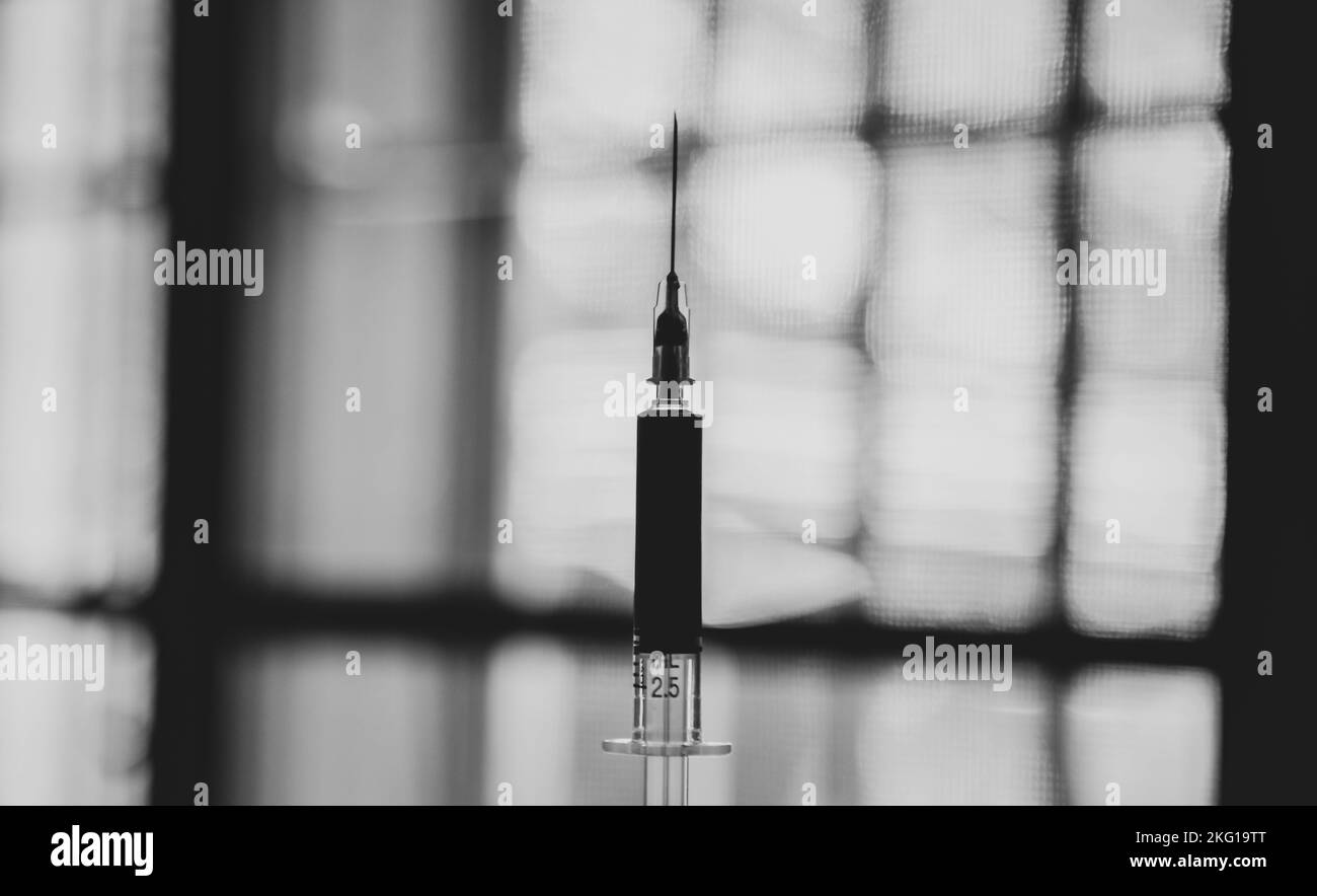 A close up of injection blood test syringe on the blurry background ...