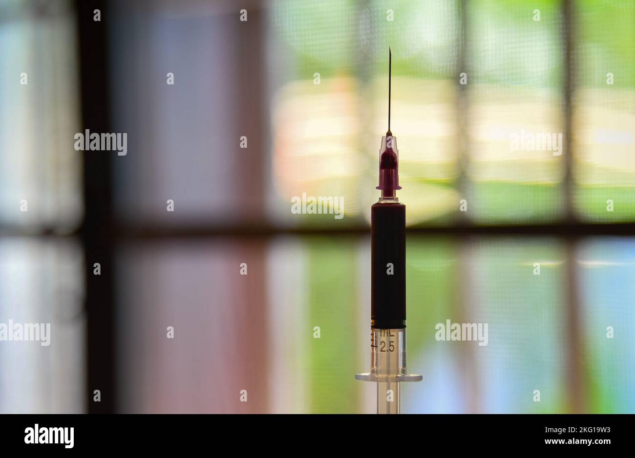 A close up of injection blood test syringe on the blurry background ...