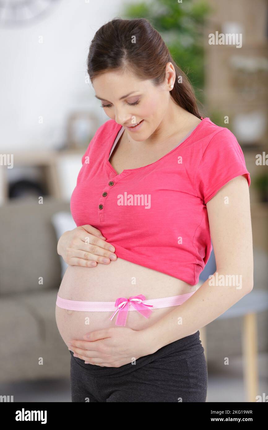 Pregnant belly pink ribbon hi-res stock photography and images - Alamy
