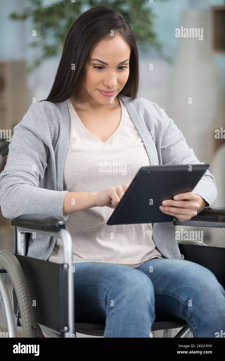 female woman with tablet ebook on wheelchair Stock Photo - Alamy