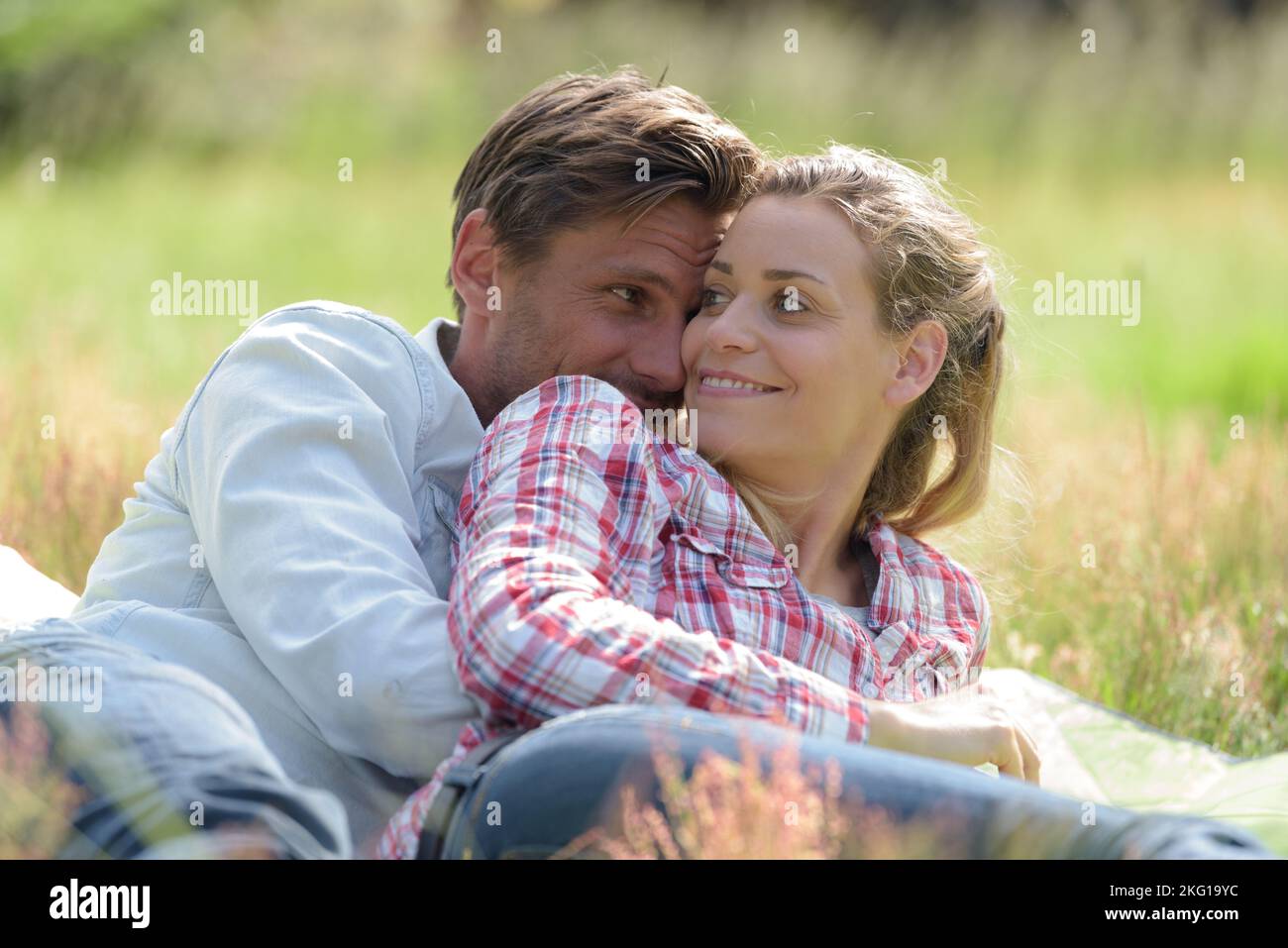 picture of couple hugging on the grass Stock Photo - Alamy