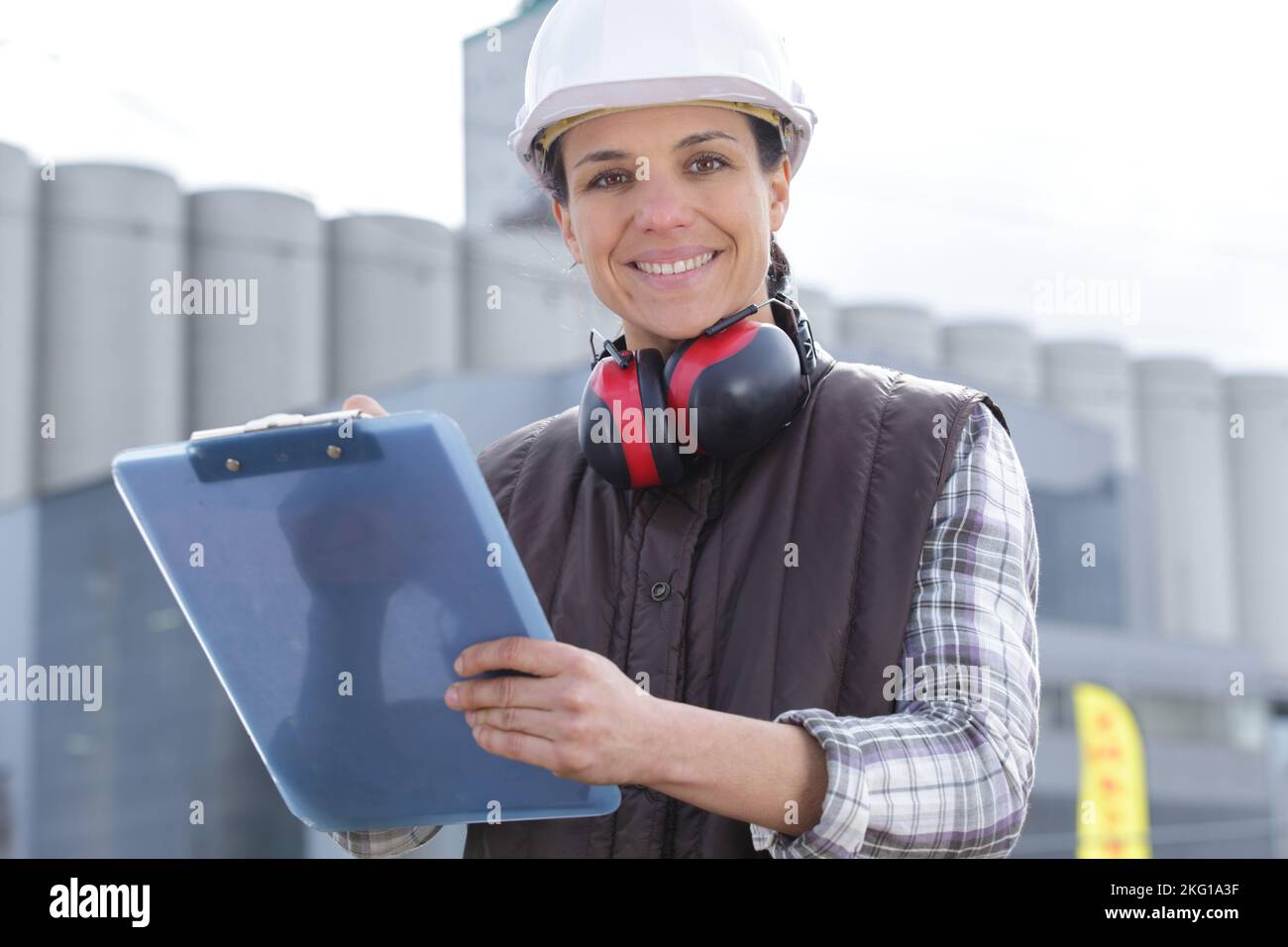 beautiful construction worker holding paper holder Stock Photo - Alamy
