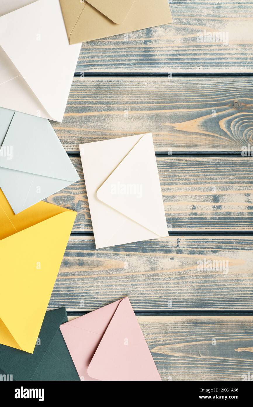 Multicolored envelopes lie randomly on gray wooden rustic textured ...