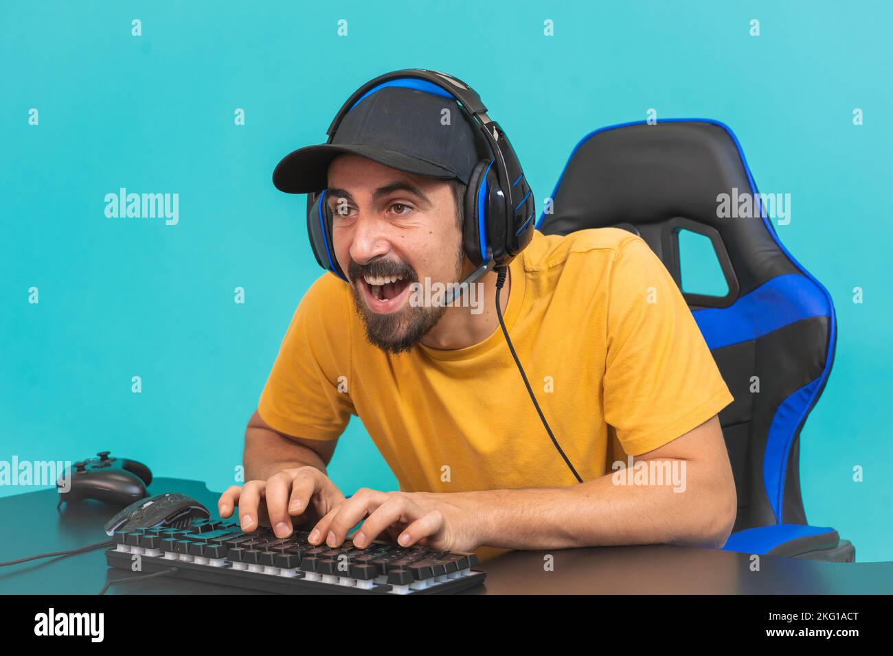 Excited handsome young male gamer playing online game on computer ...