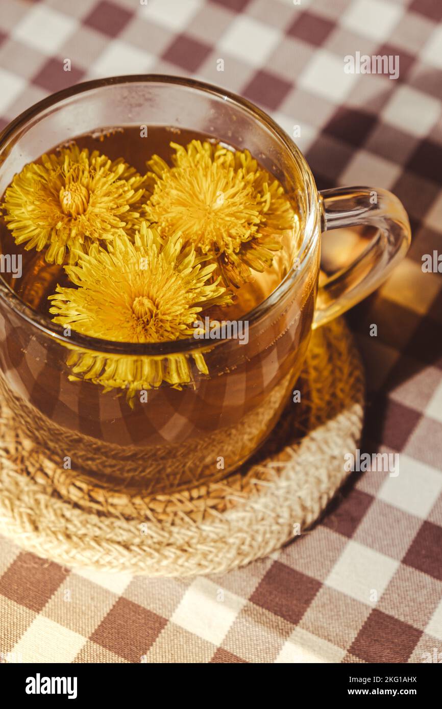 Dandelion flower healthy tea in glass cup on table. Herbal medicine ...