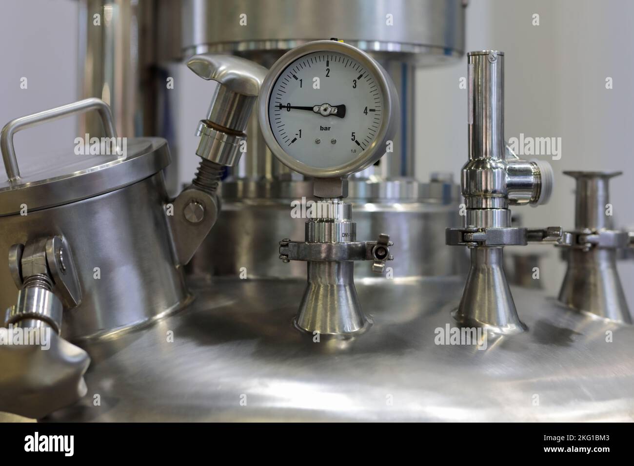 Stainless steel chemical reactor with pressure gauge. Selective focus ...