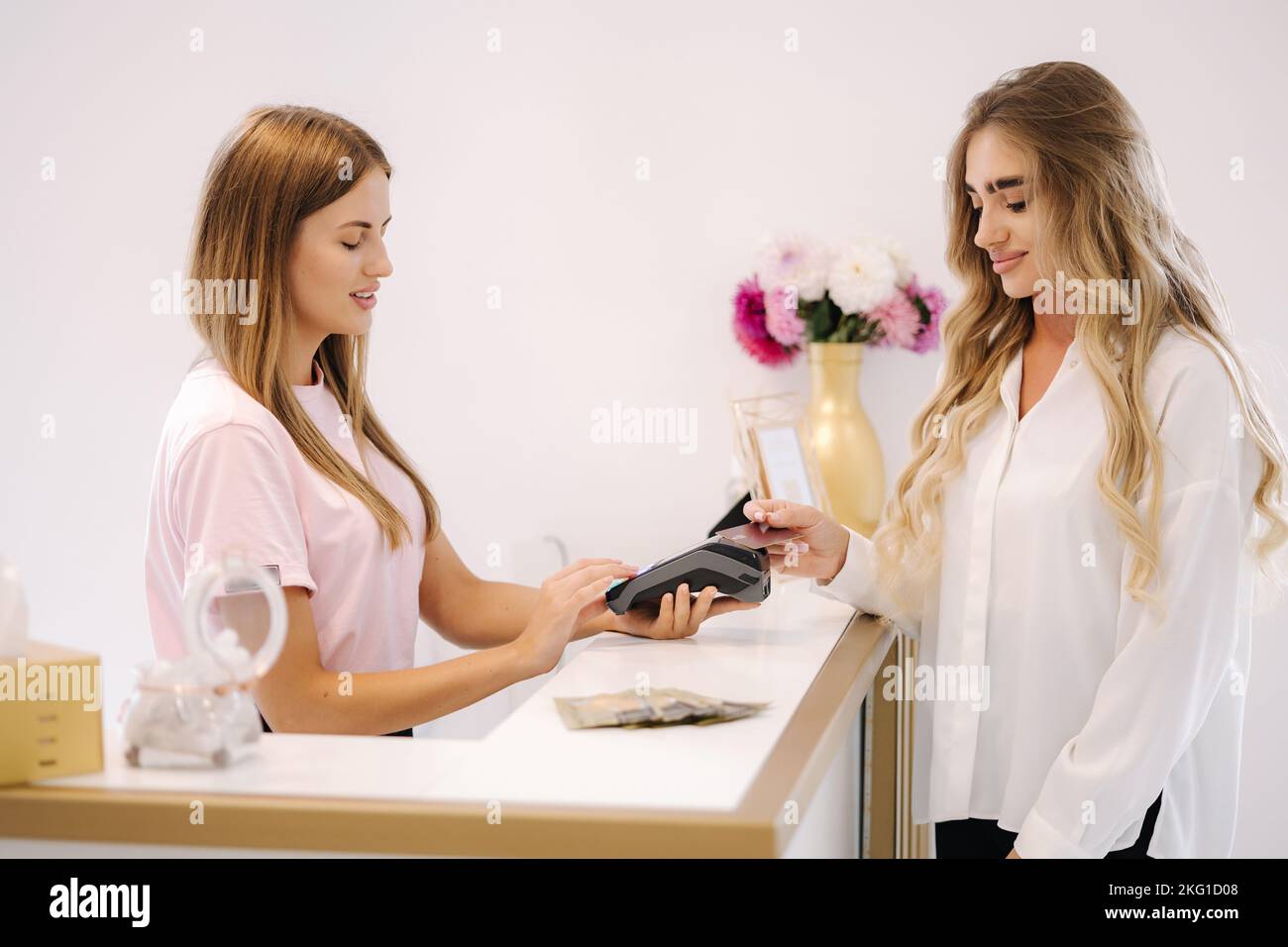 Female customer pay for procedures in beauty studio. Woman using credit ... Female customer pay for procedures in beauty studio. Woman using credit ...