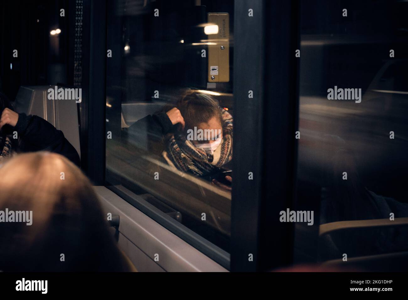 Girl on bus looking at phone Stock Photo - Alamy