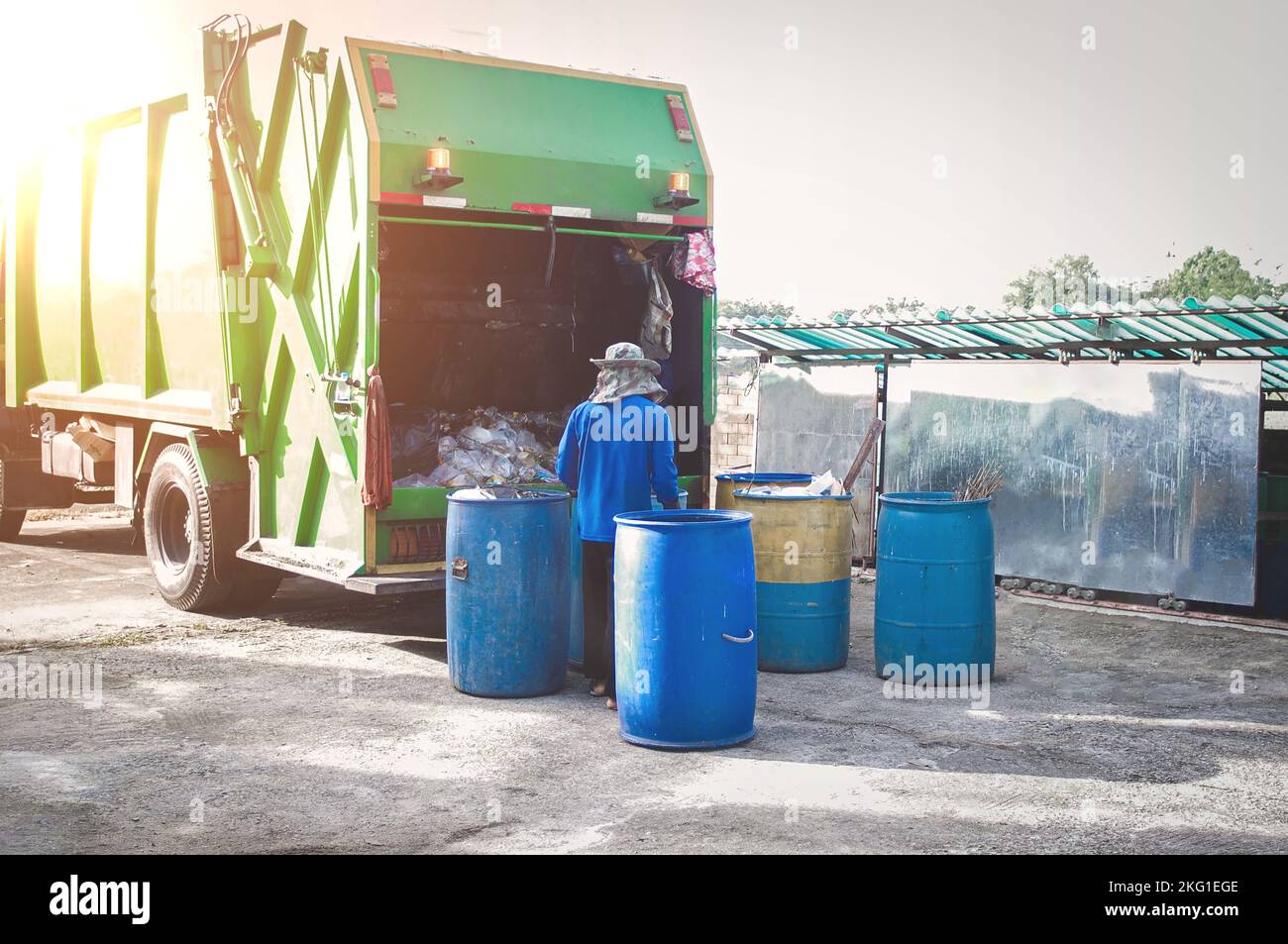 Garbage transportation workers. Scavengers take bins. Men load a metal ...