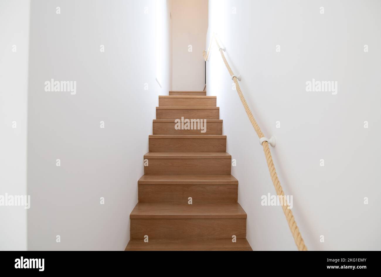 Staircase with white walls and a rope handrail Stock Photo - Alamy