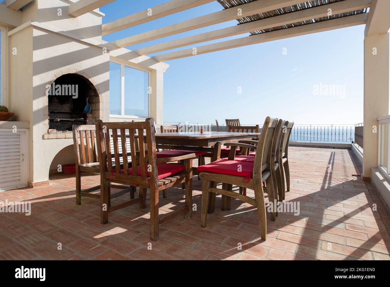 Outdoor dining area with table and chairs on a paved terrace Stock ...