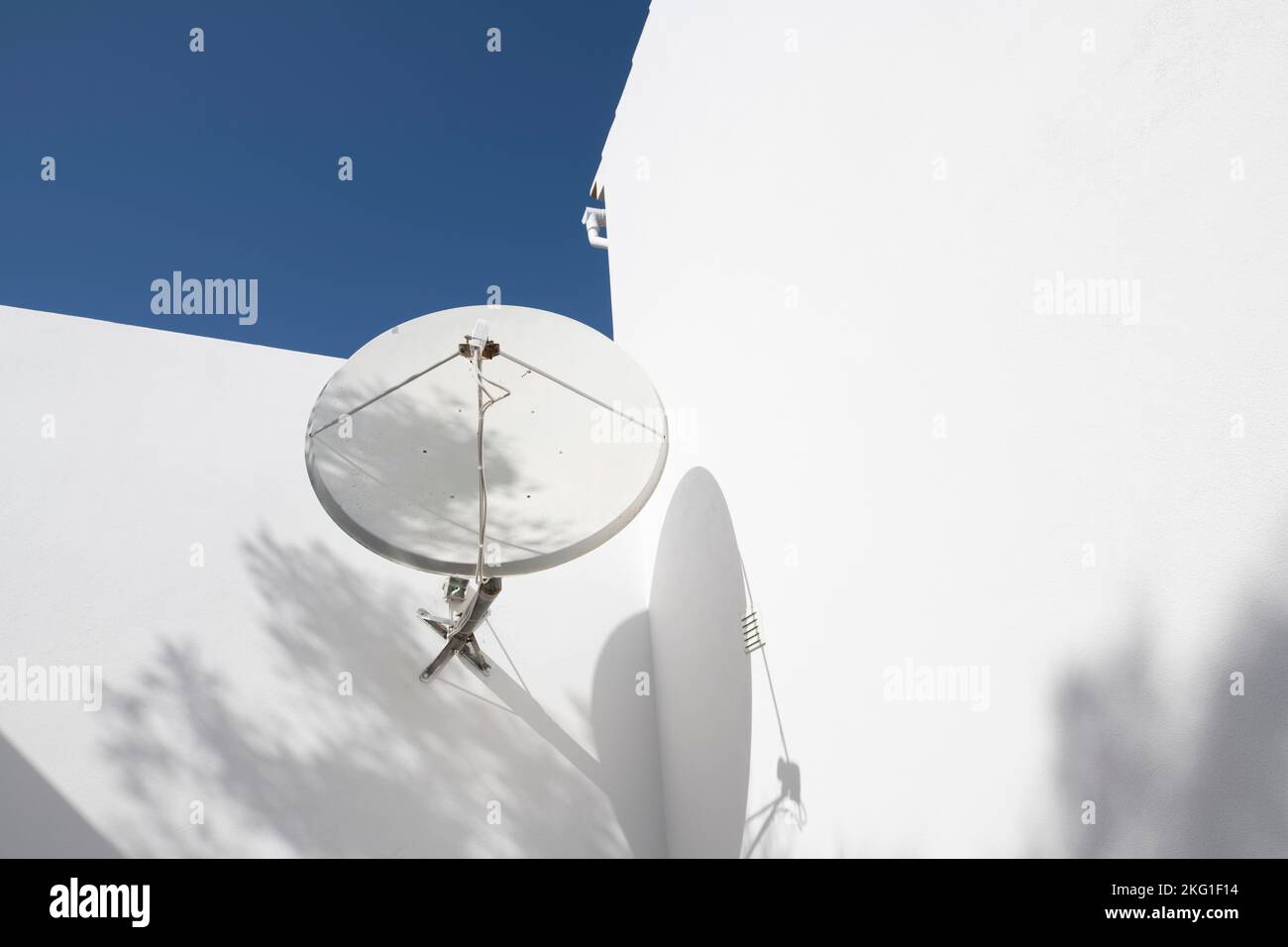 TV Satellite dish on the wall of a white house Stock Photo - Alamy