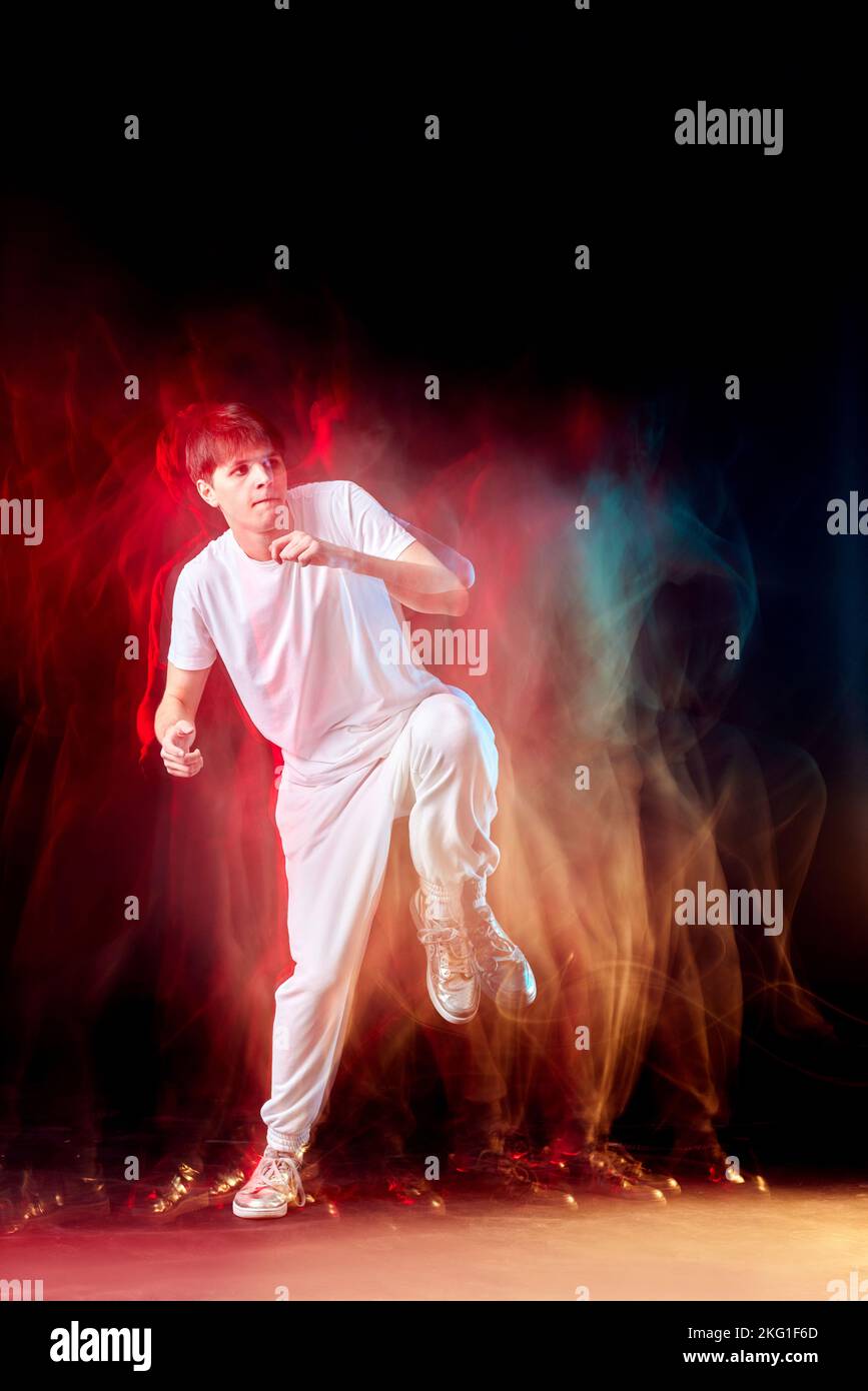 guy moving cheerfully in mixed neon light Stock Photo - Alamy