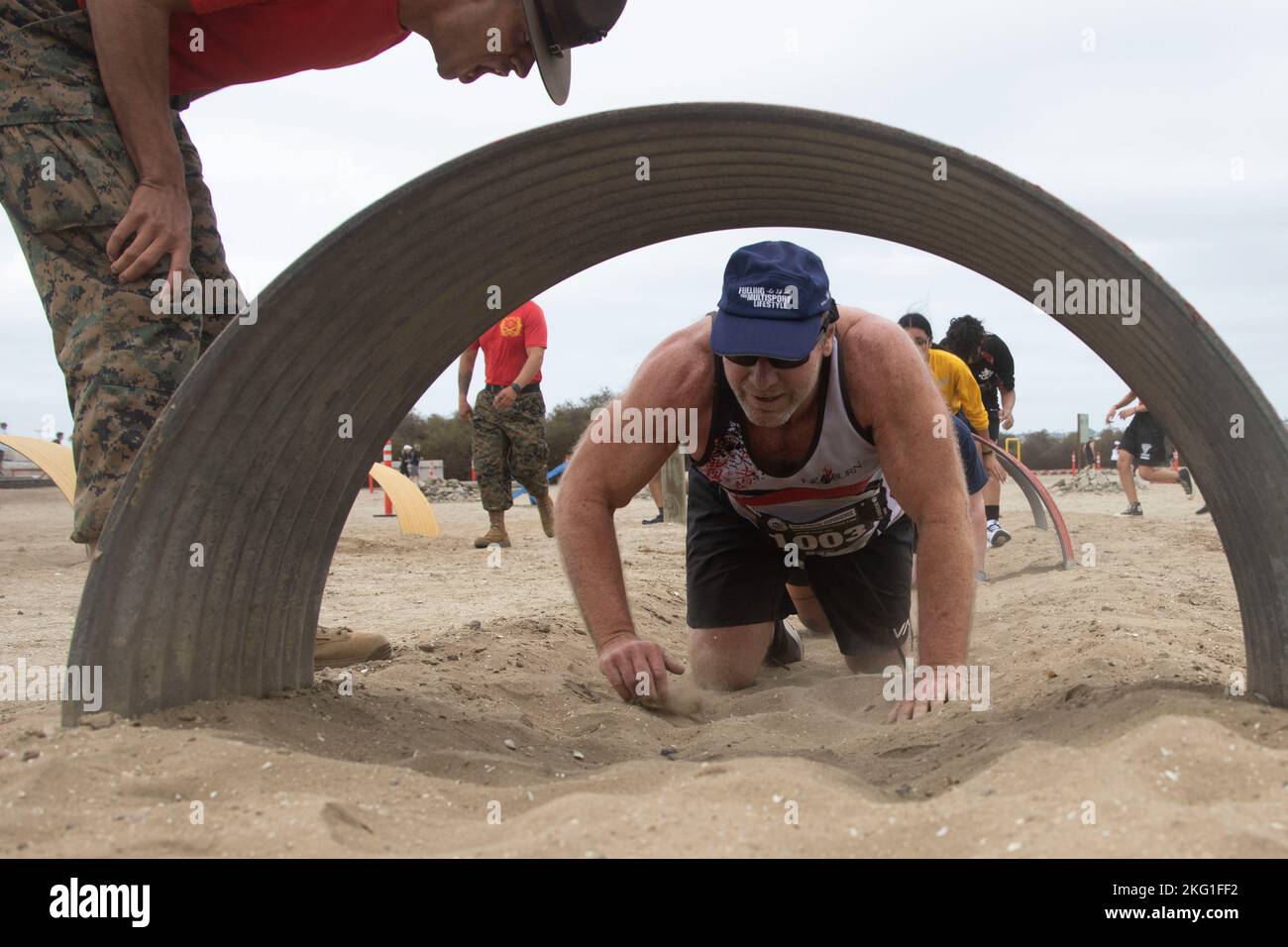 A Boot Camp Challenge participant crawls in a race at Marine Corps ...