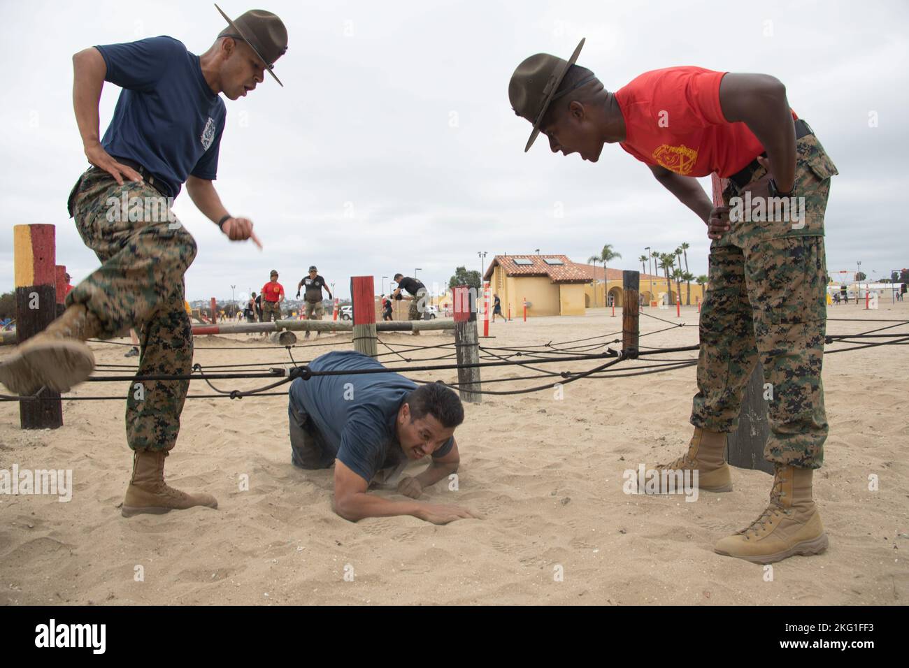 A Boot Camp Challenge participant crawls in a race at Marine Corps ...