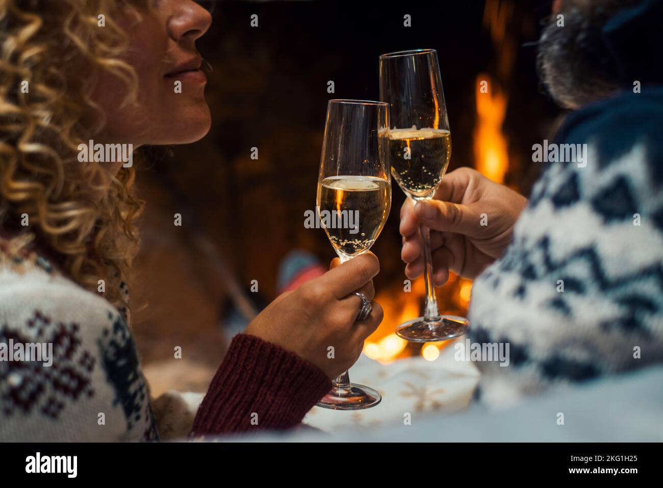 Side close up view of romantic couple celebrating together drinking ...