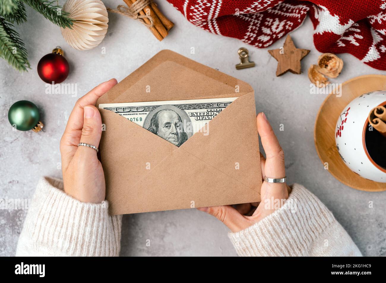Girl counting US Dollar bills, wrapping in envelop. Woman hands doing ...