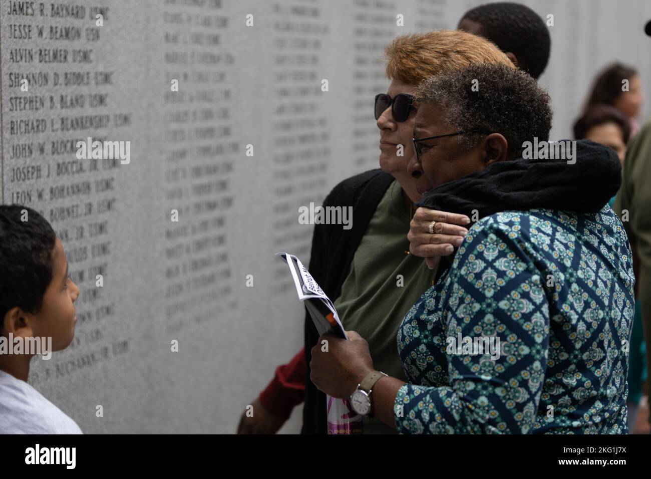 Caroline Barrett, center, hugs Thomasine Baynard, right, the spouse of ...