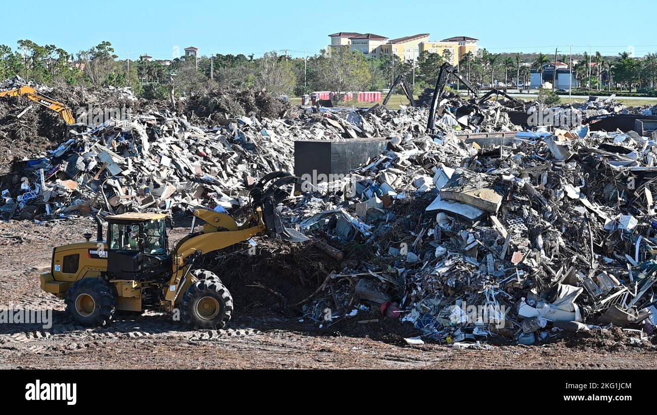 Construction equipment manages debris at a temporary collection point ...