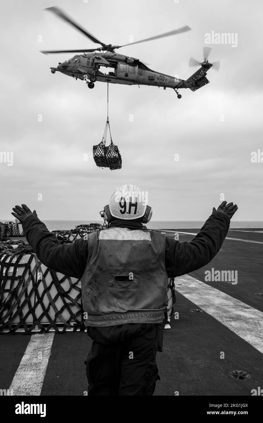221023-N-ZG822-1533 ADRIATIC SEA (Oct. 23 2022) A Sailor signals an MH ...
