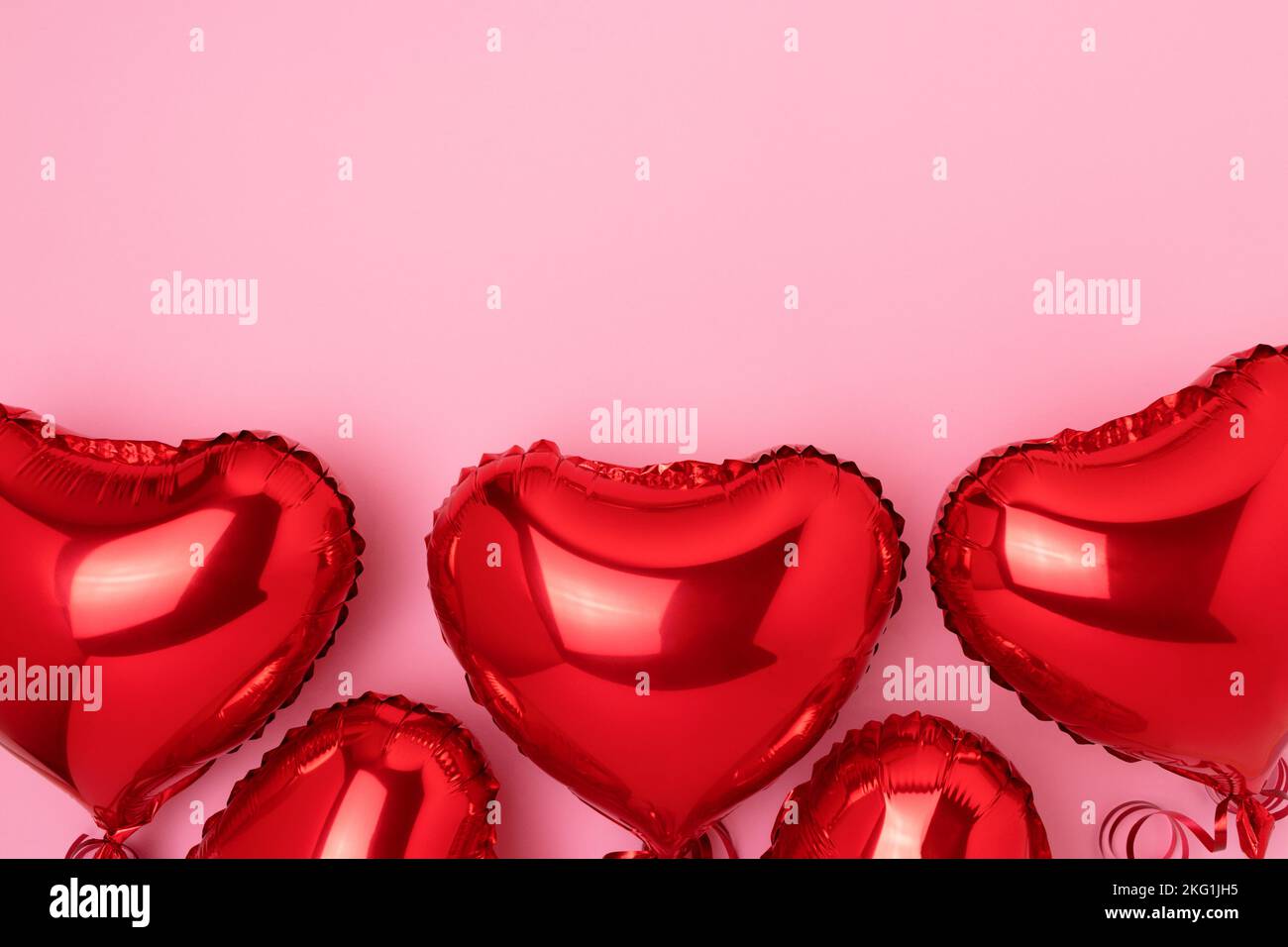 Frame made of red inflatable foil balloons in a heart shape. Concept on ...
