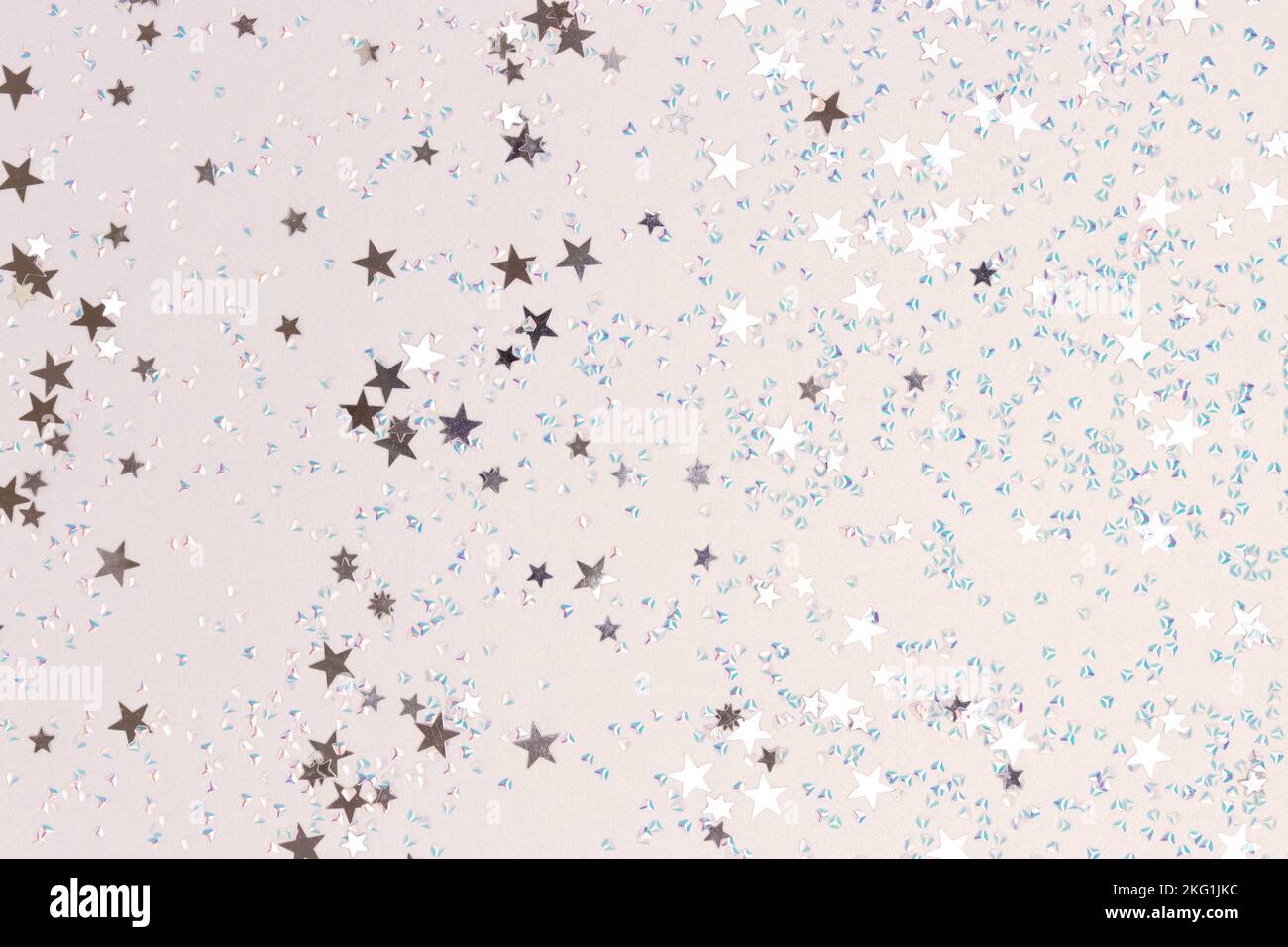 Shimmer stars and blue crystals confetti on a silver background. Shiny ...