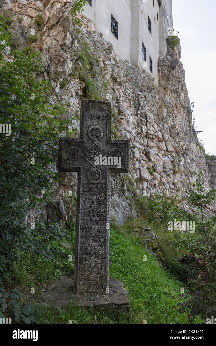Well-preserved ancient stone cross with text artfully engraved in small ...