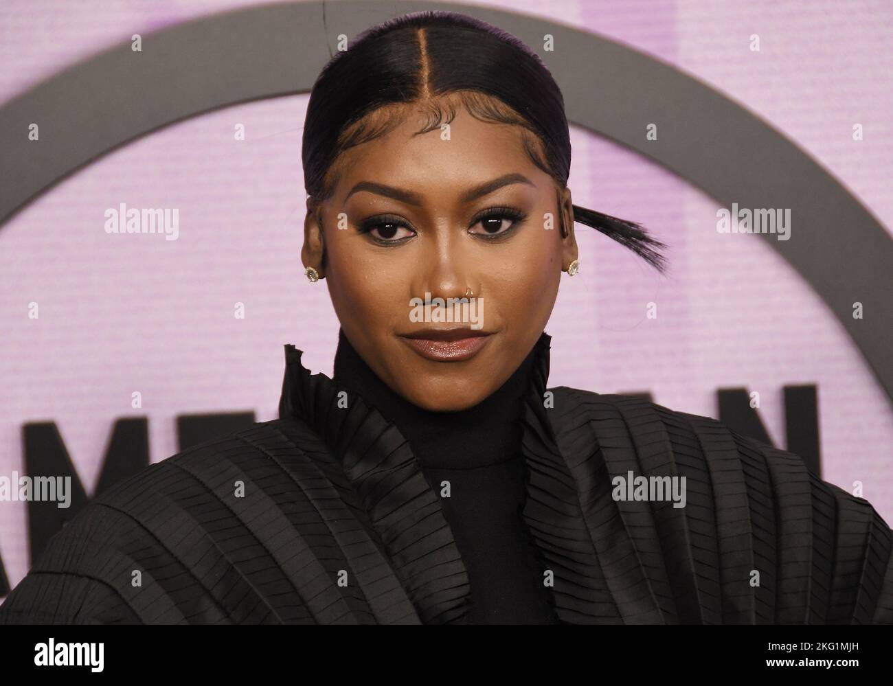 Muni Long arrives at the 2022 American Music Awards held at the ...
