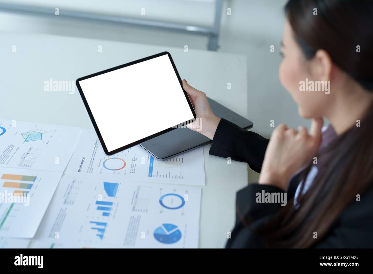 A white screen tablet computer placed on the desk at work. Can put text ...