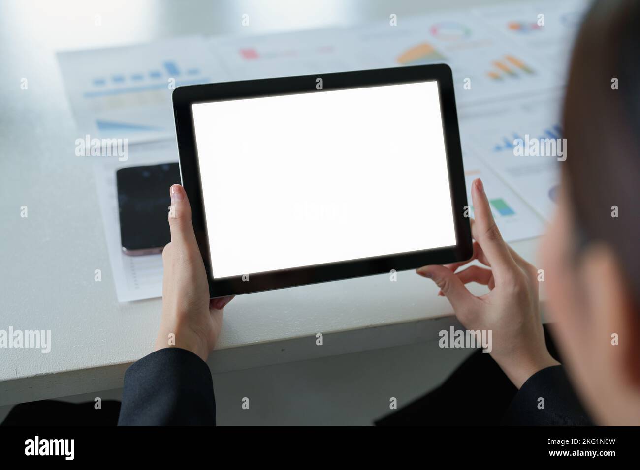 A white screen tablet computer placed on the desk at work. Can put text ...