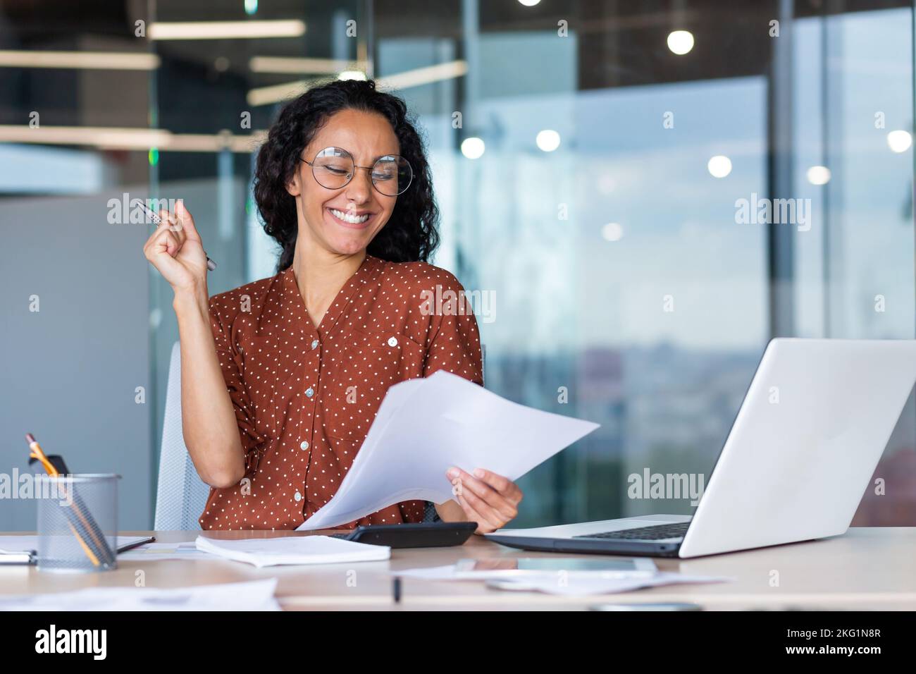 Successful woman celebrating reading documents hi-res stock photography ...