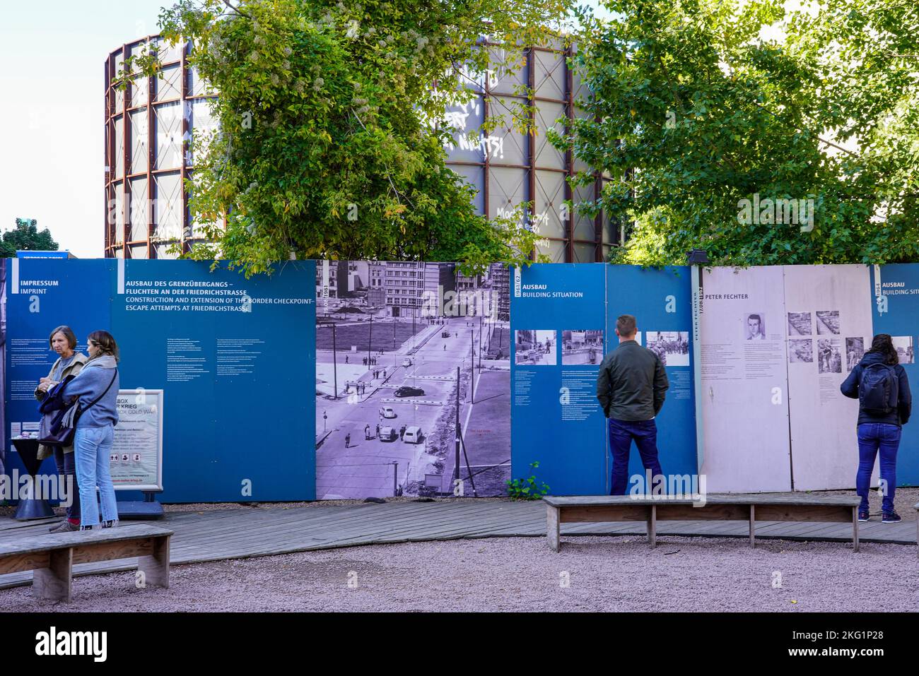 Tourists visit the outdoor exhibition at Checkpoint Charlie. The former ...