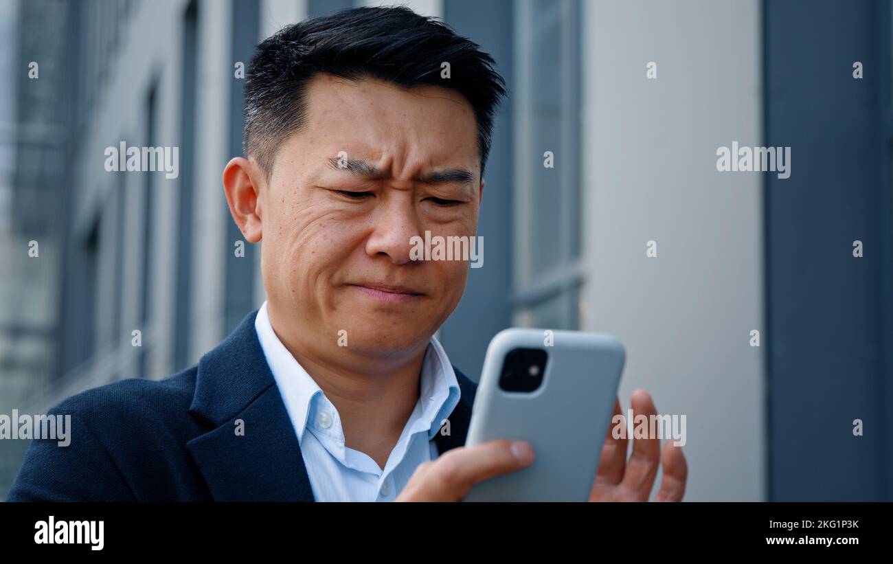 Close up angry worried stressed Asian middle-aged 40s man user ...