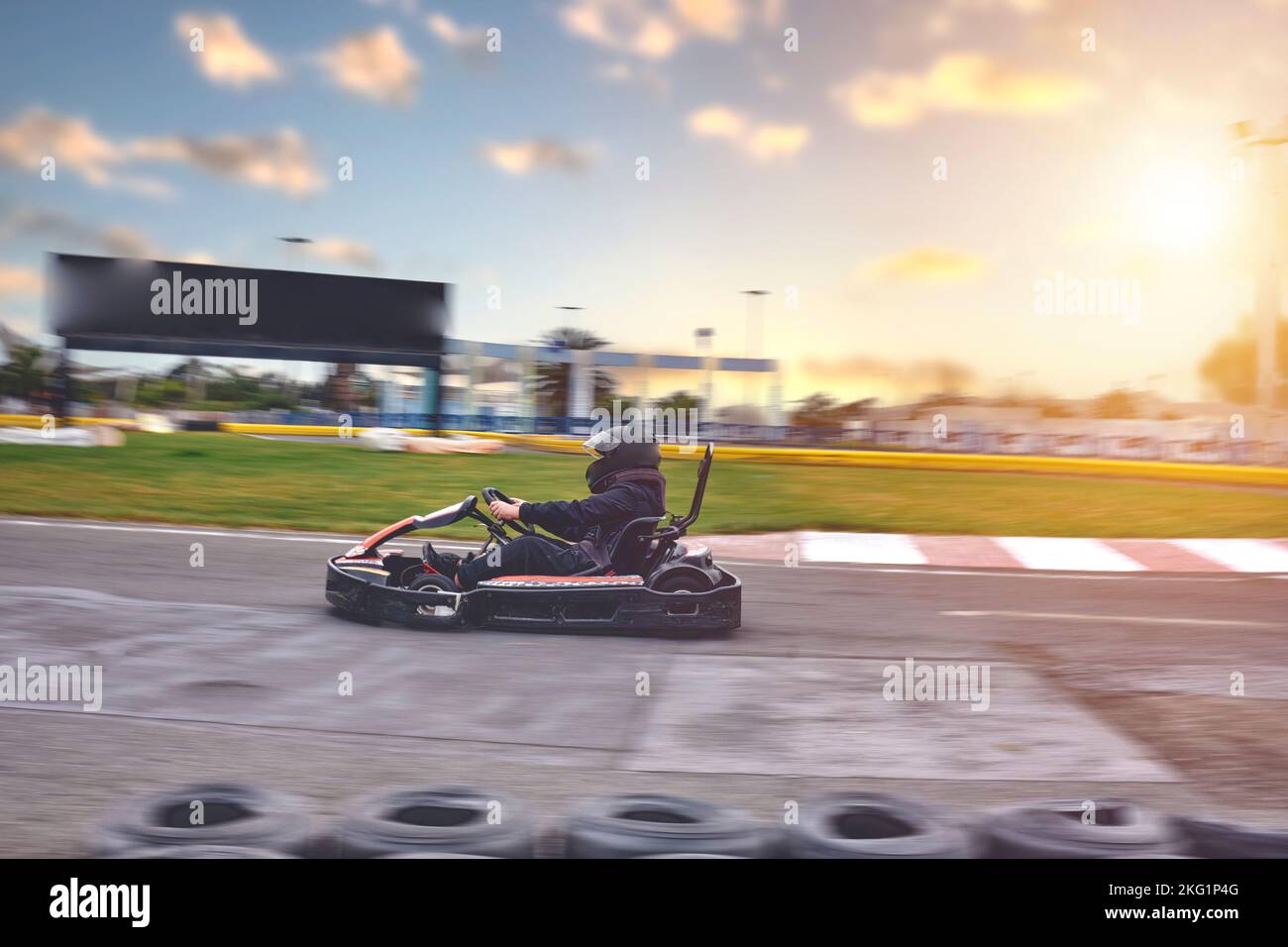 A driver in gear and helmet drives a racing car. Go karts racing ...