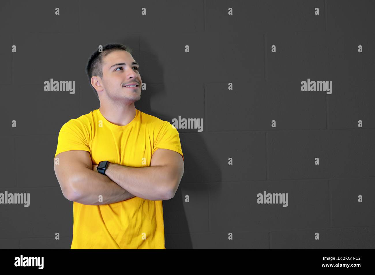 Nice picture with young caucasian male athlete crossing his arms ...