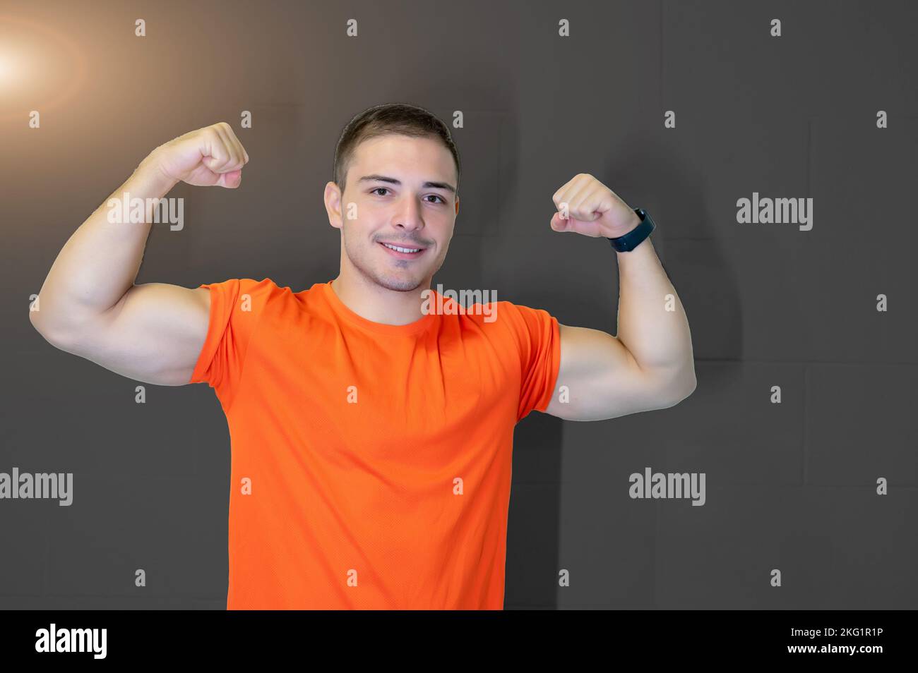 Nice picture with young caucasian male athlete flexing his arms smiling ...