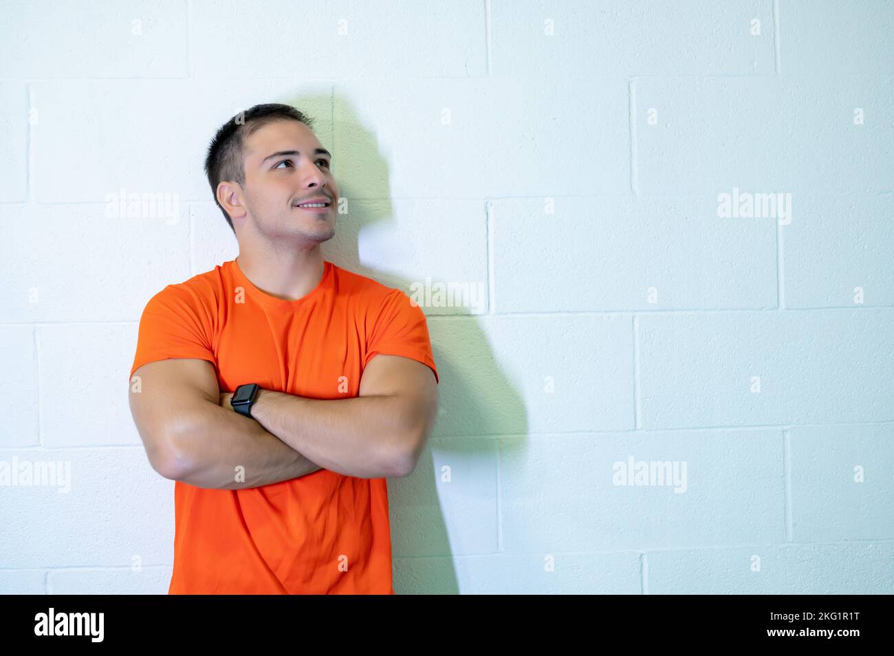 Nice picture with young caucasian male athlete crossing his arms ...