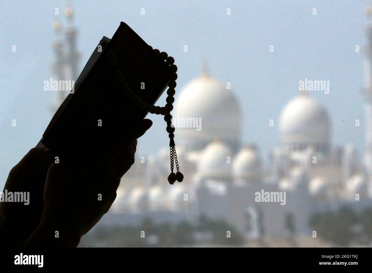 Silhouette of a Muslim woman reading the Holy Quran. Sheikh Zayed Grand ...
