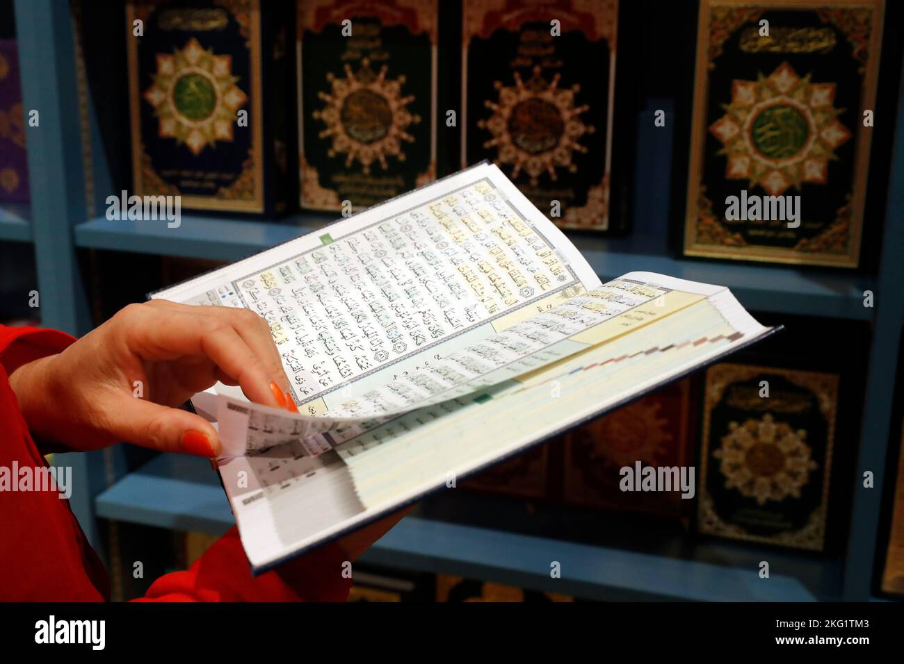 Muslim woman buying a Holy Quran in a bookstore. Dubai. United Arab ...