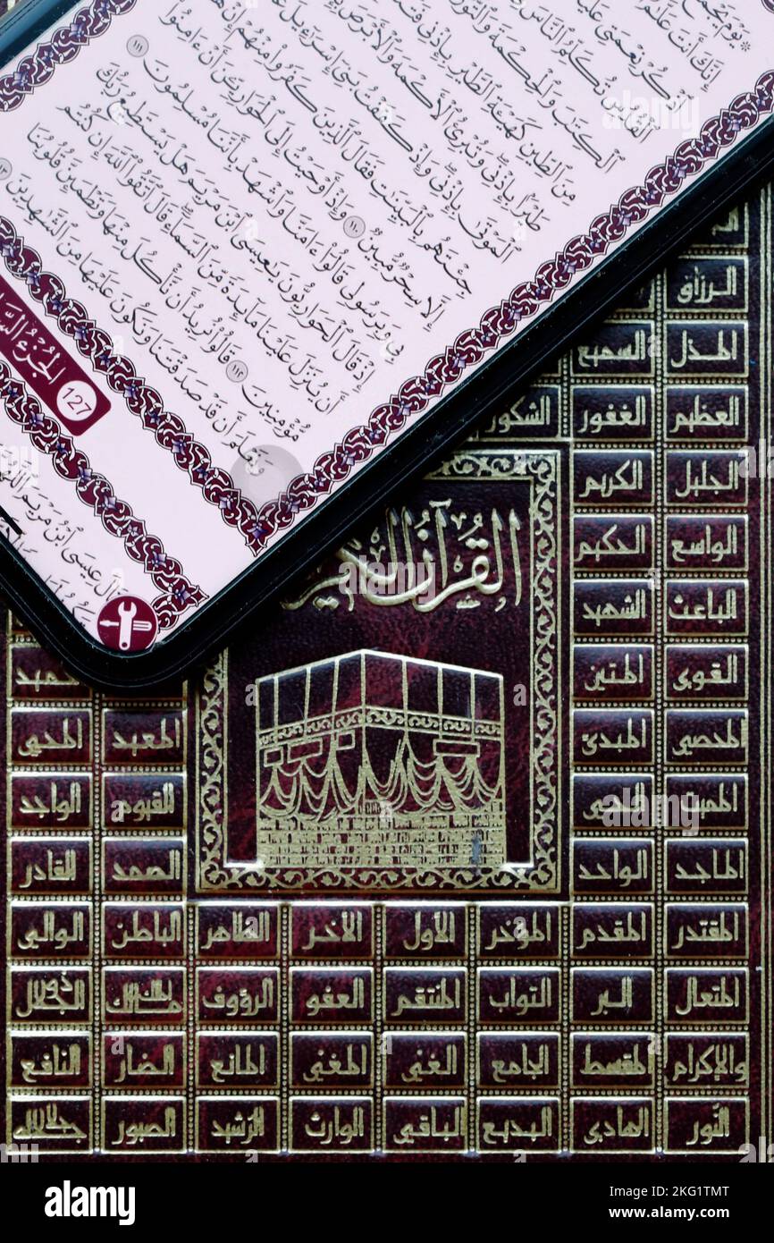 Digital Quran on a tablet and traditional Holy Quran on paper Stock ...