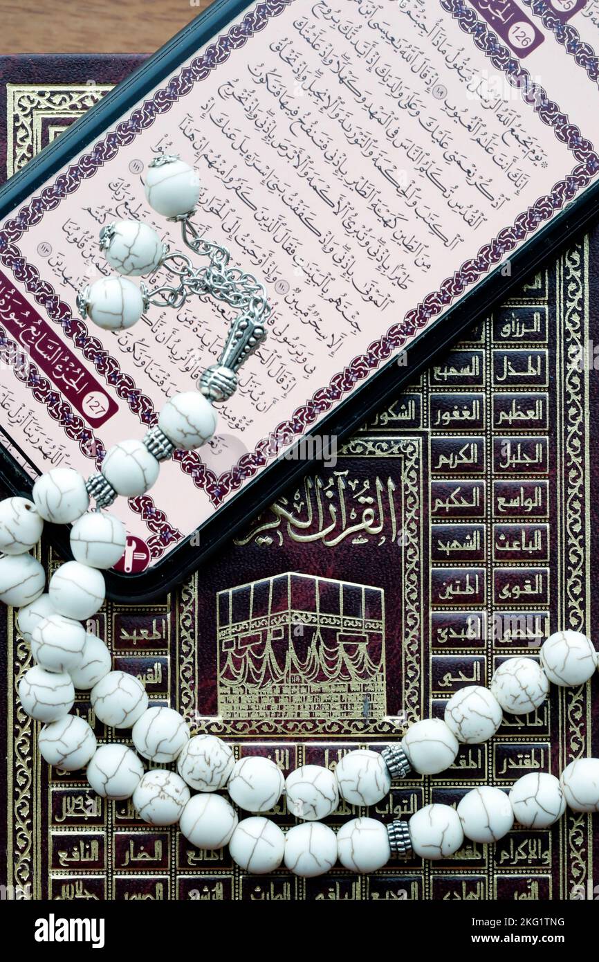 Digital Quran on a tablet and traditional Holy Quran on paper Stock ...