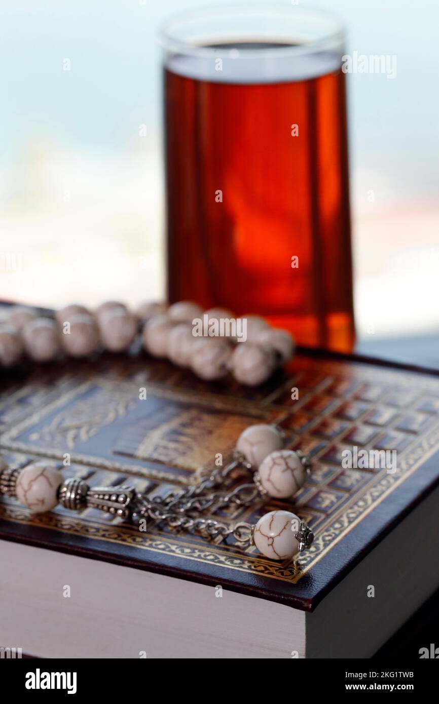 Holy Quran in arabic, muslim prayer beads, glass of tea. Islam symbols ...