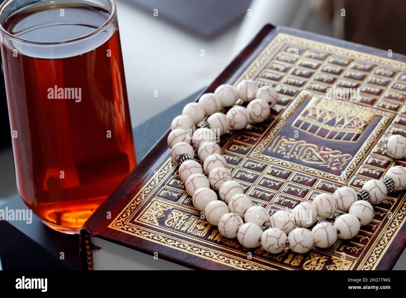 Holy Quran in arabic, muslim prayer beads, glass of tea. Islam symbols ...