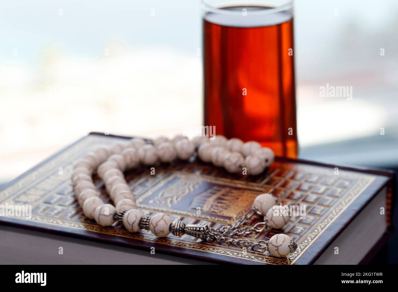 Holy Quran in arabic, muslim prayer beads, glass of tea. Islam symbols ...