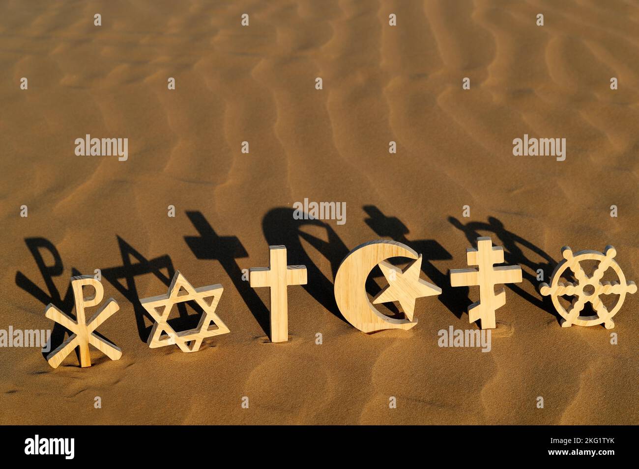Religious symbols on sand at sunset : Catholic, Islam, Judaism ...