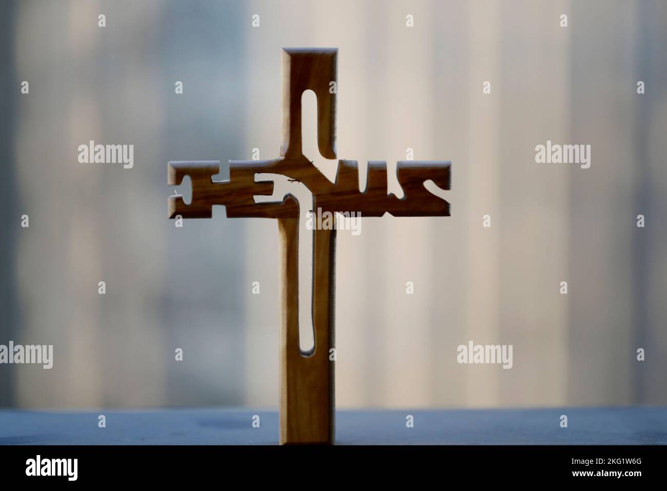 A wooden christian cross with the name of Jesus. Symbol of religion and ...